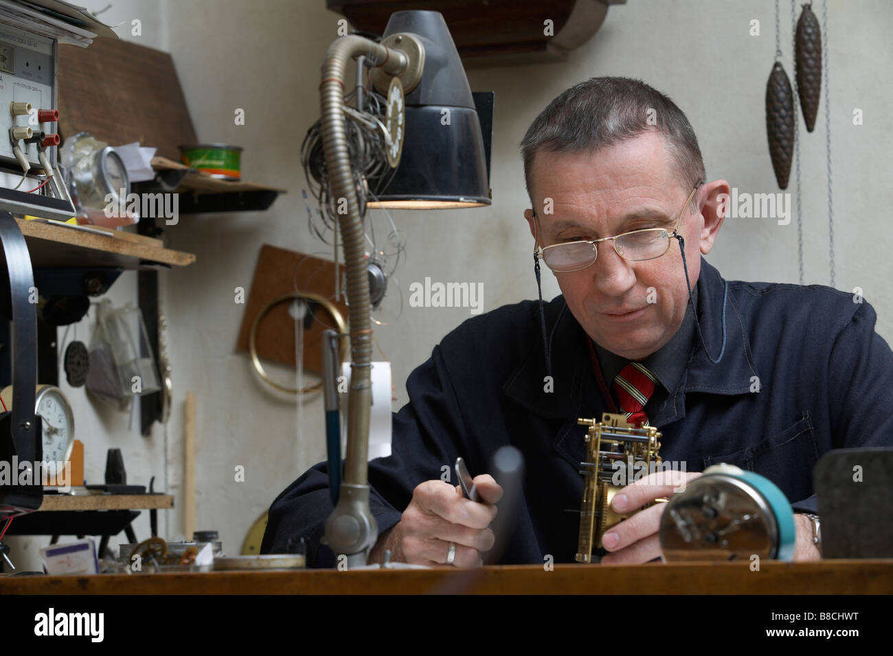 Clock Repairman at Work Stock Photo - Alamy