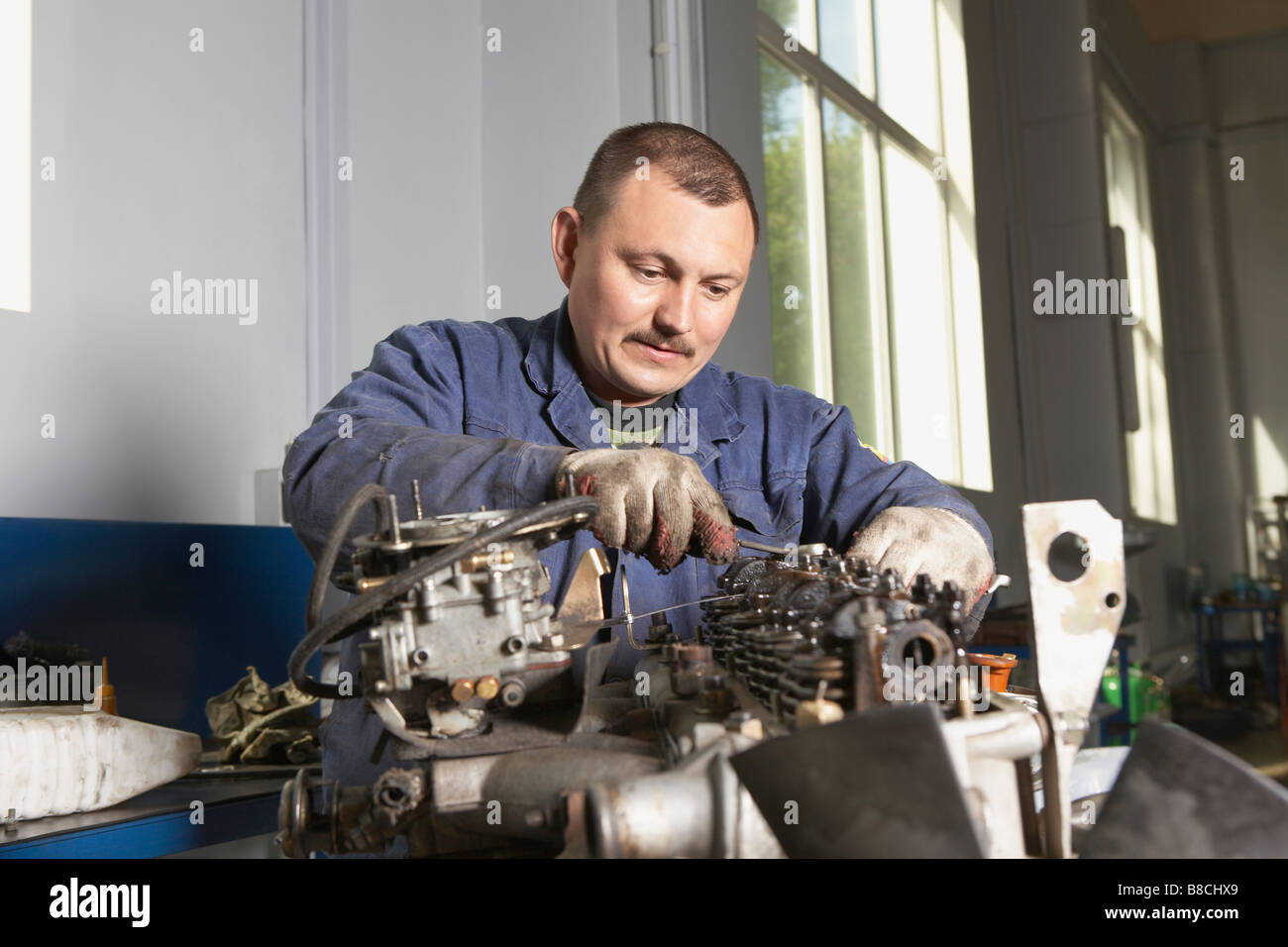 Mechanic Working on Motor Stock Photo - Alamy