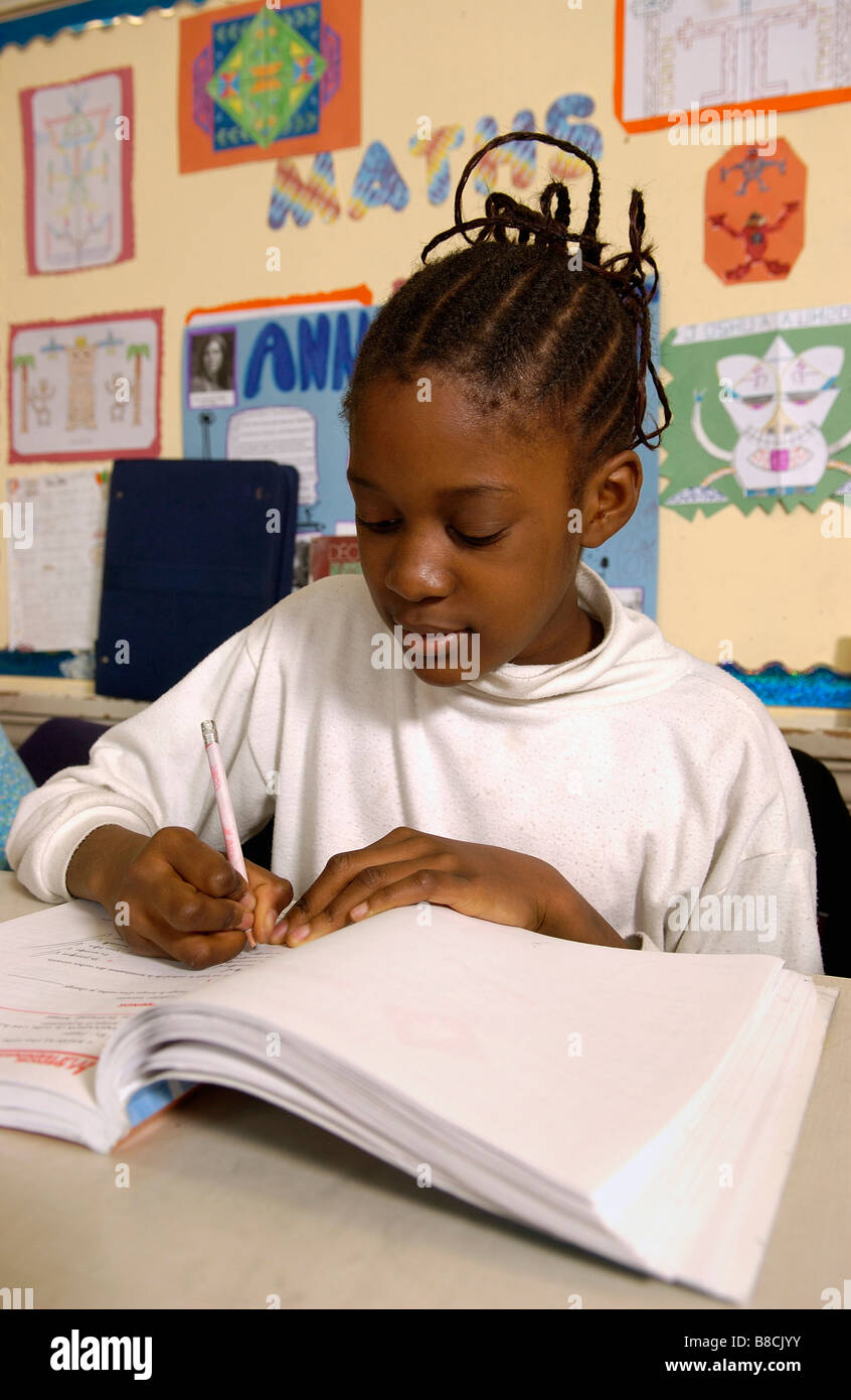 Girl, Grade 5, working her Desk Classroom Stock Photo - Alamy