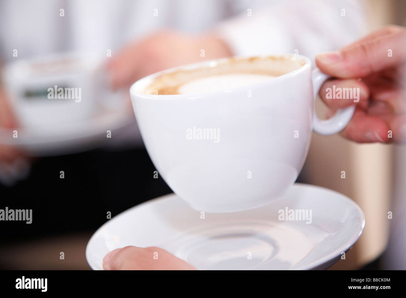 Two people sat drinking coffee Stock Photo - Alamy
