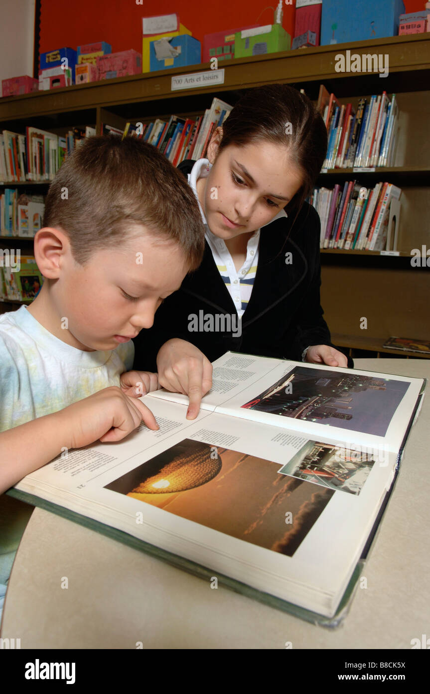 High School Student helping Gradee Student Library Stock Photo - Alamy