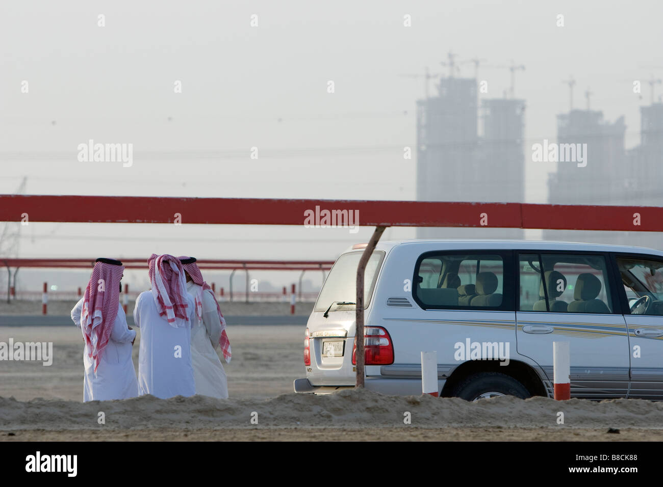Dubai, UAE, group of Muslim men wearing traditional dishdash and gutras ...