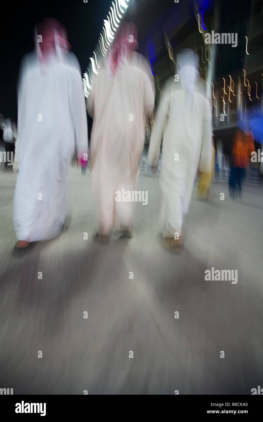 Dubai, UAE, small group of traditionally dressed Muslim men roaming ...