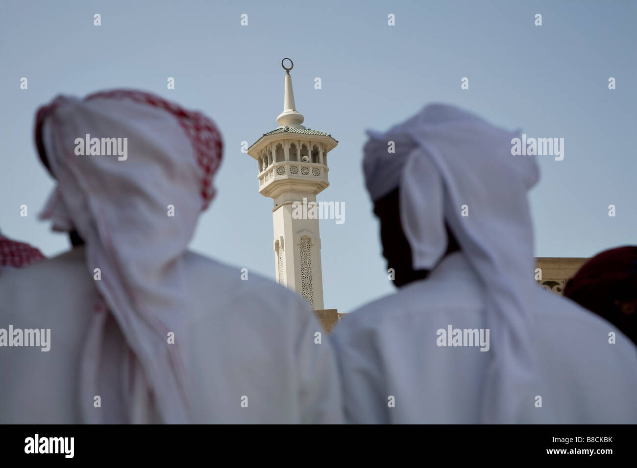 UAE, Dubai, group of traditionally dressed Muslim men perform a song ...