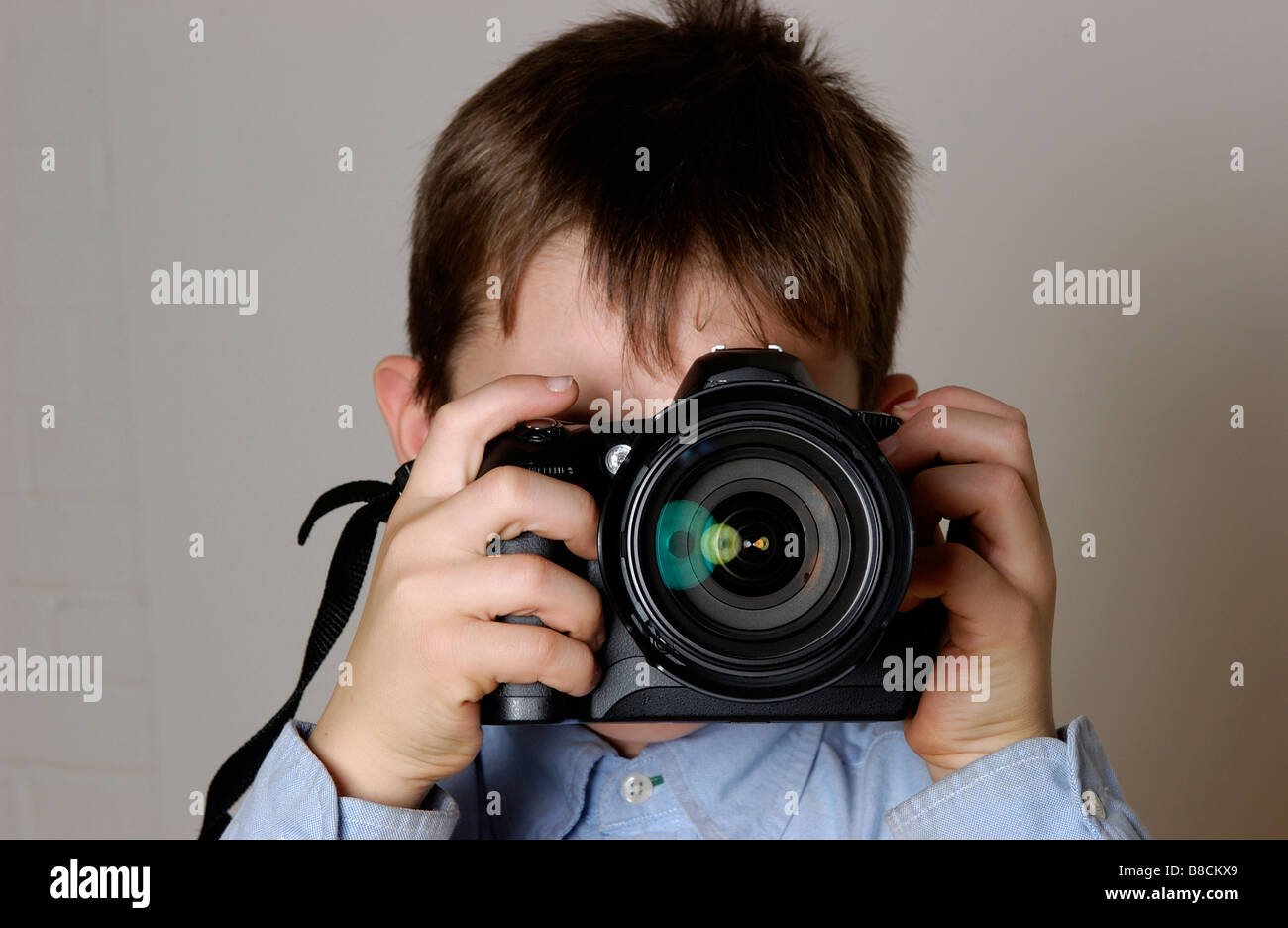 Boy Looking through Camera Stock Photo - Alamy