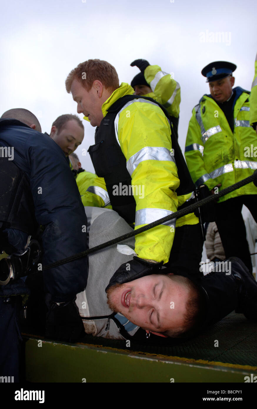 A POLICEMAN AND SECURITY GUARD APPREHEND A MAN AT STONEHENGE DURING ...