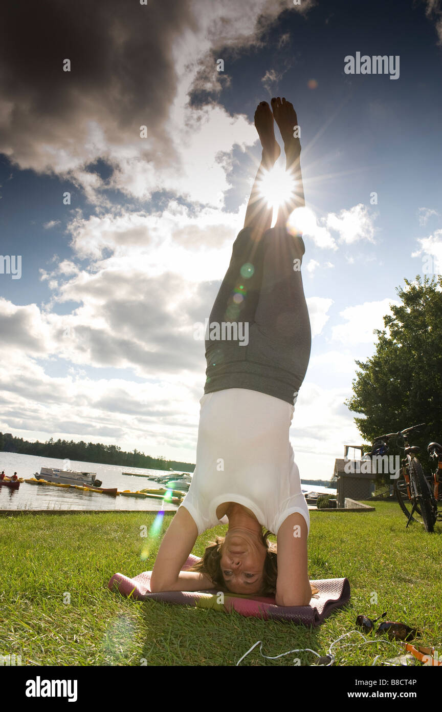 Woman doing headstand Stock Photo - Alamy