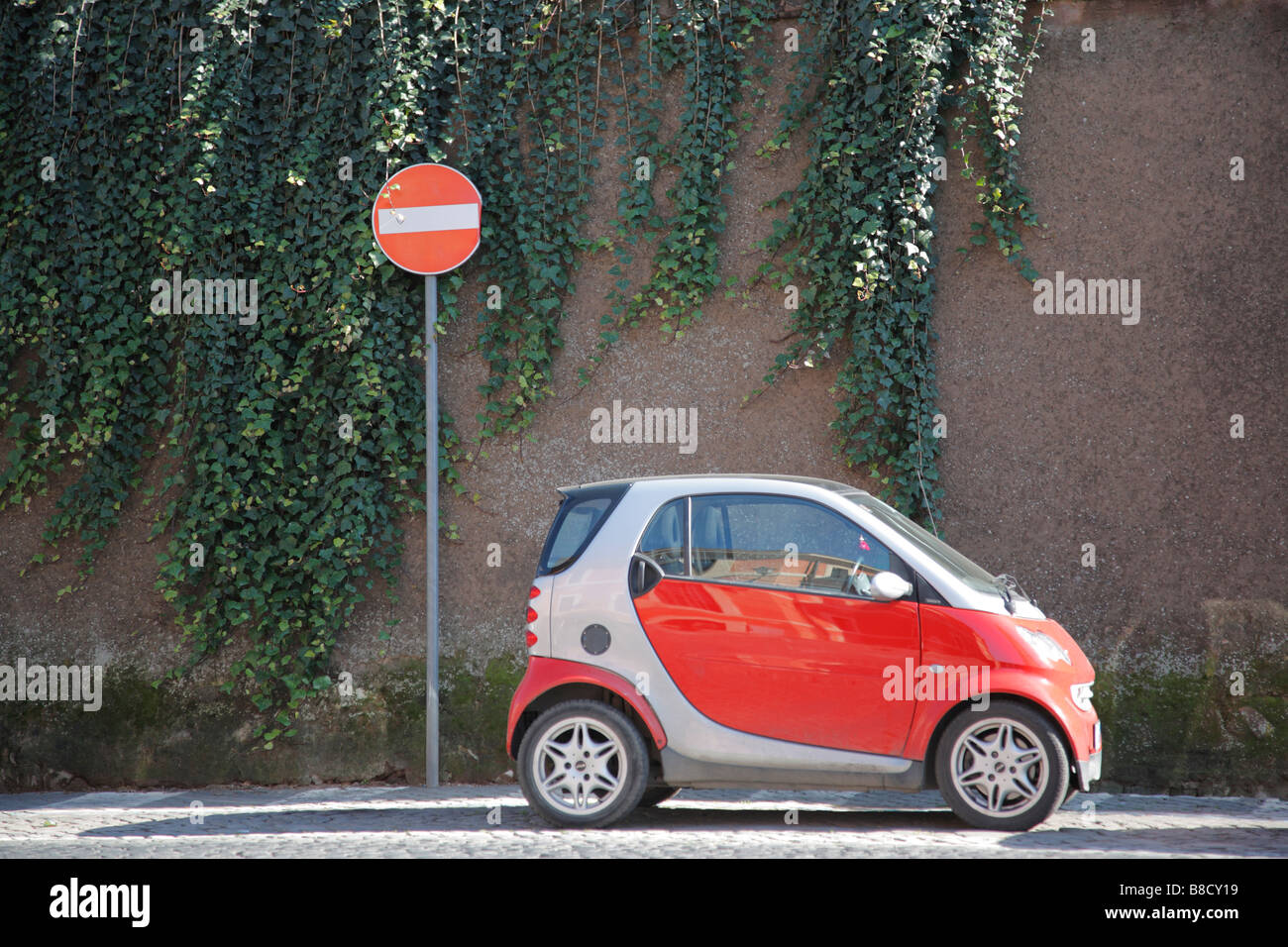 Small car parked on a street, Rome, Italy Stock Photo - Alamy