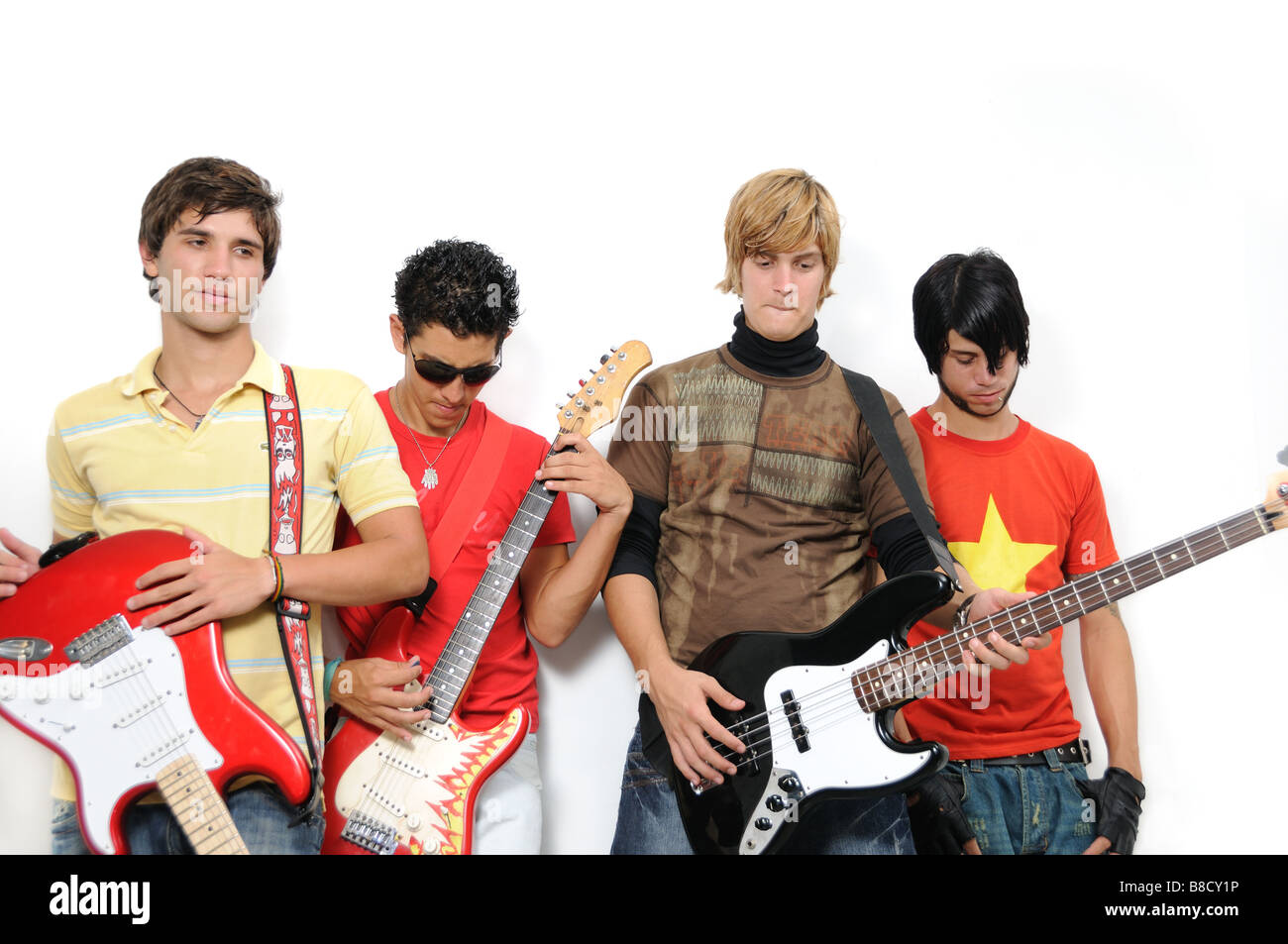 Portrait of young trendy teenager group posing with musical intruments ...