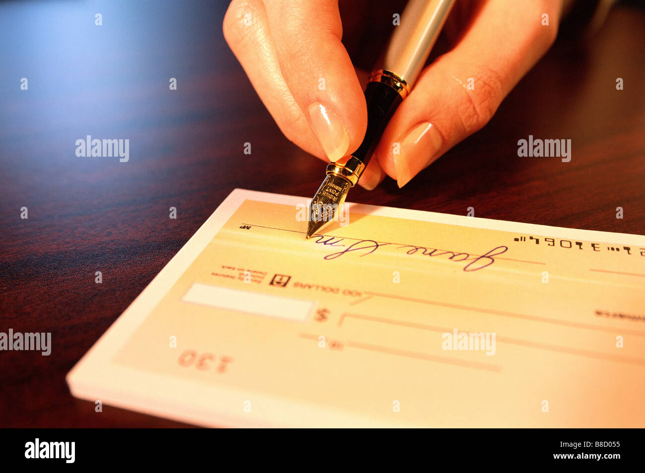 Female hand writing cheque hi-res stock photography and images - Alamy