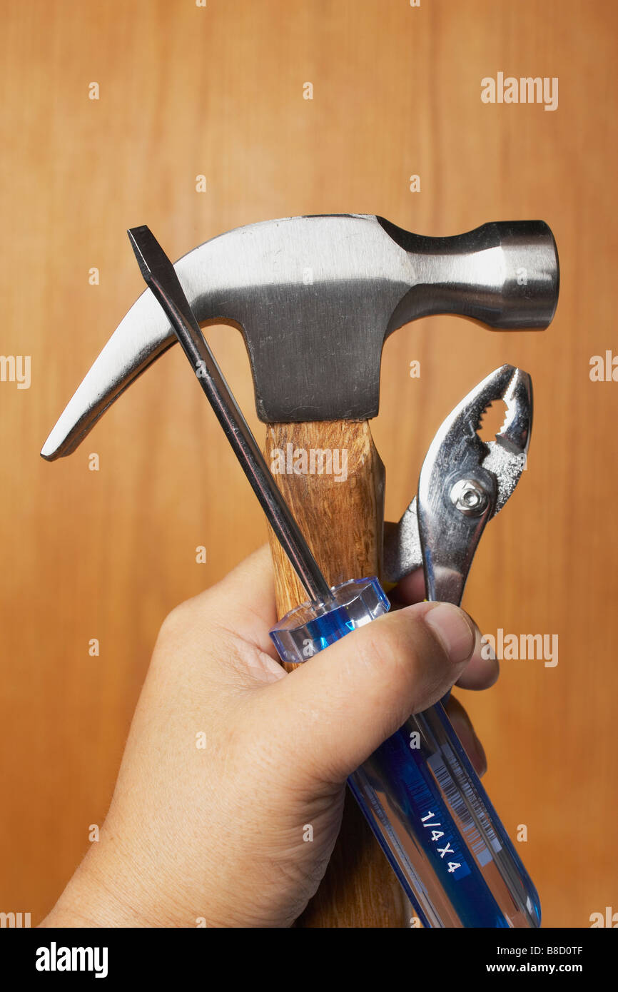 Hand holding Tools Stock Photo - Alamy