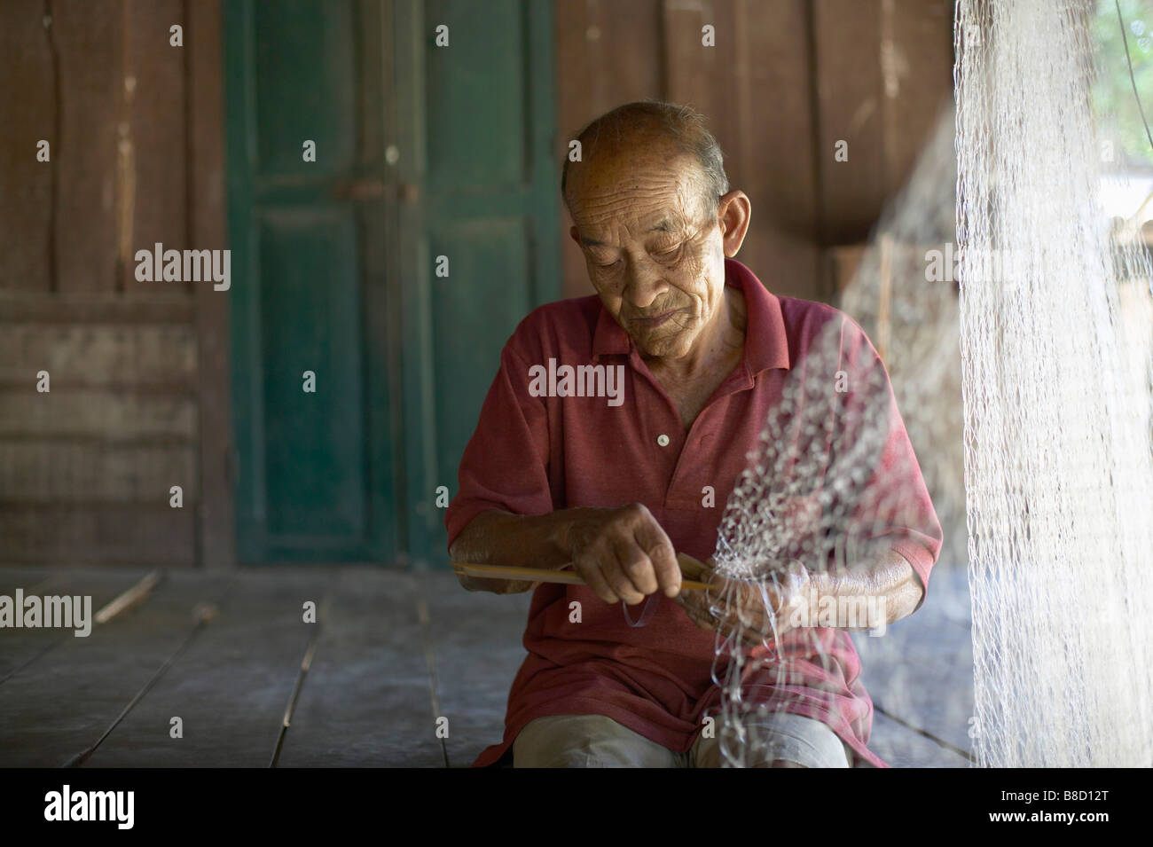 Man Making Fish Net, Laos Stock Photo - Alamy