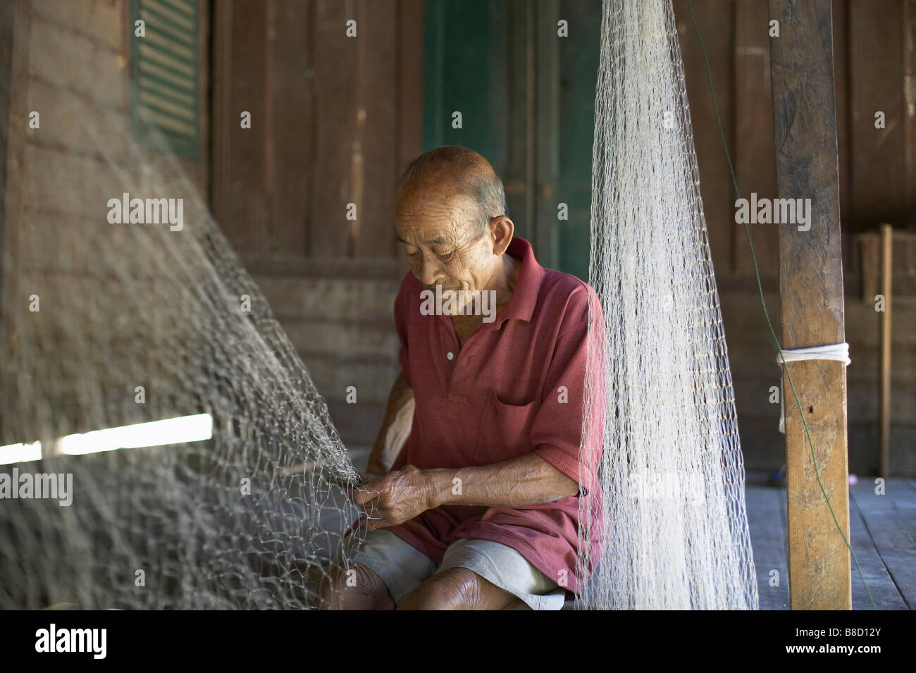 Man Making Fish Net, Laos Stock Photo - Alamy