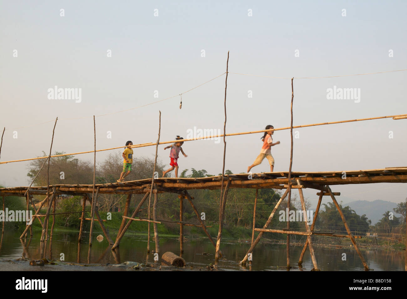 Kids Running Bridge, Laos Stock Photo - Alamy