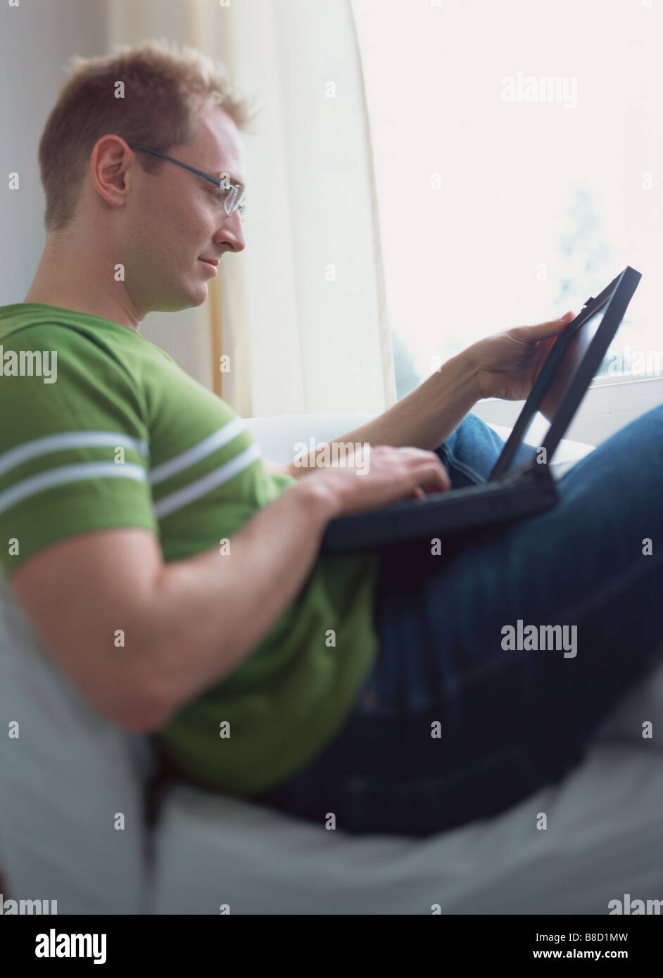 FV2641, Zoomphotographics; Man uses laptop Stock Photo - Alamy