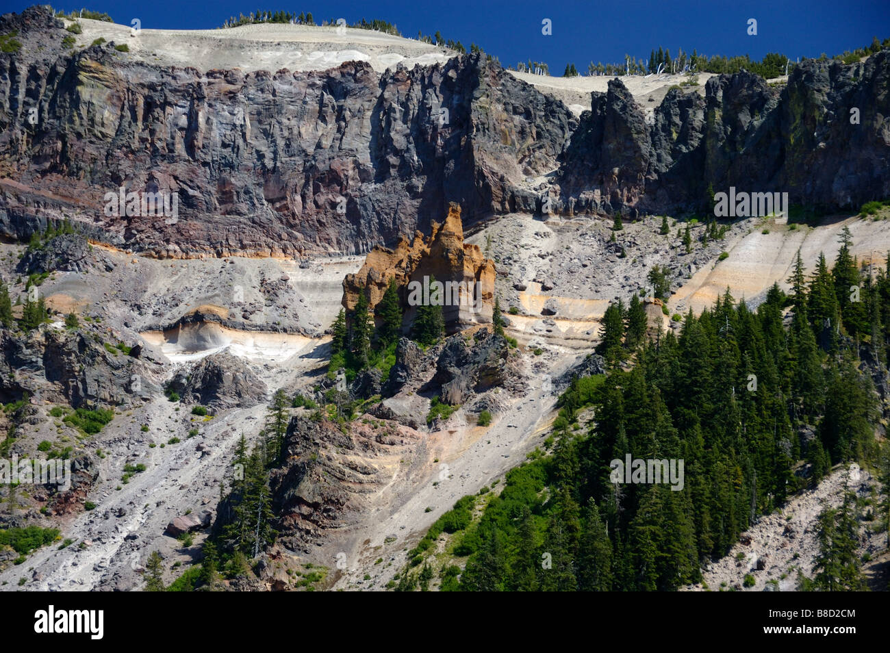 The Pumice castle on a rocky cliff of the Crater Lake rim. The Crater ...