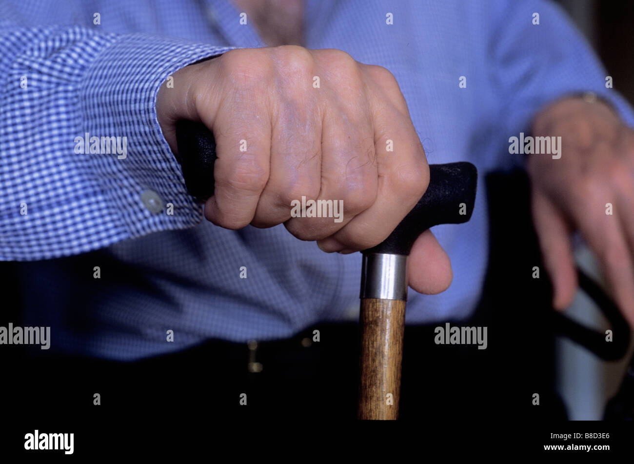 Elderly disabled man holding a cane or walking stick. Handicapped ...