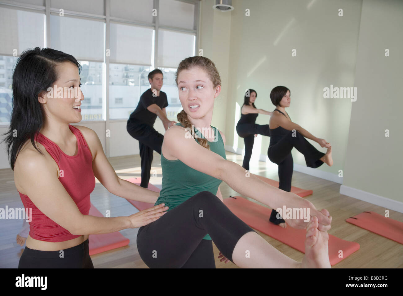 Diverse female instructor assisting woman hi-res stock photography and ...