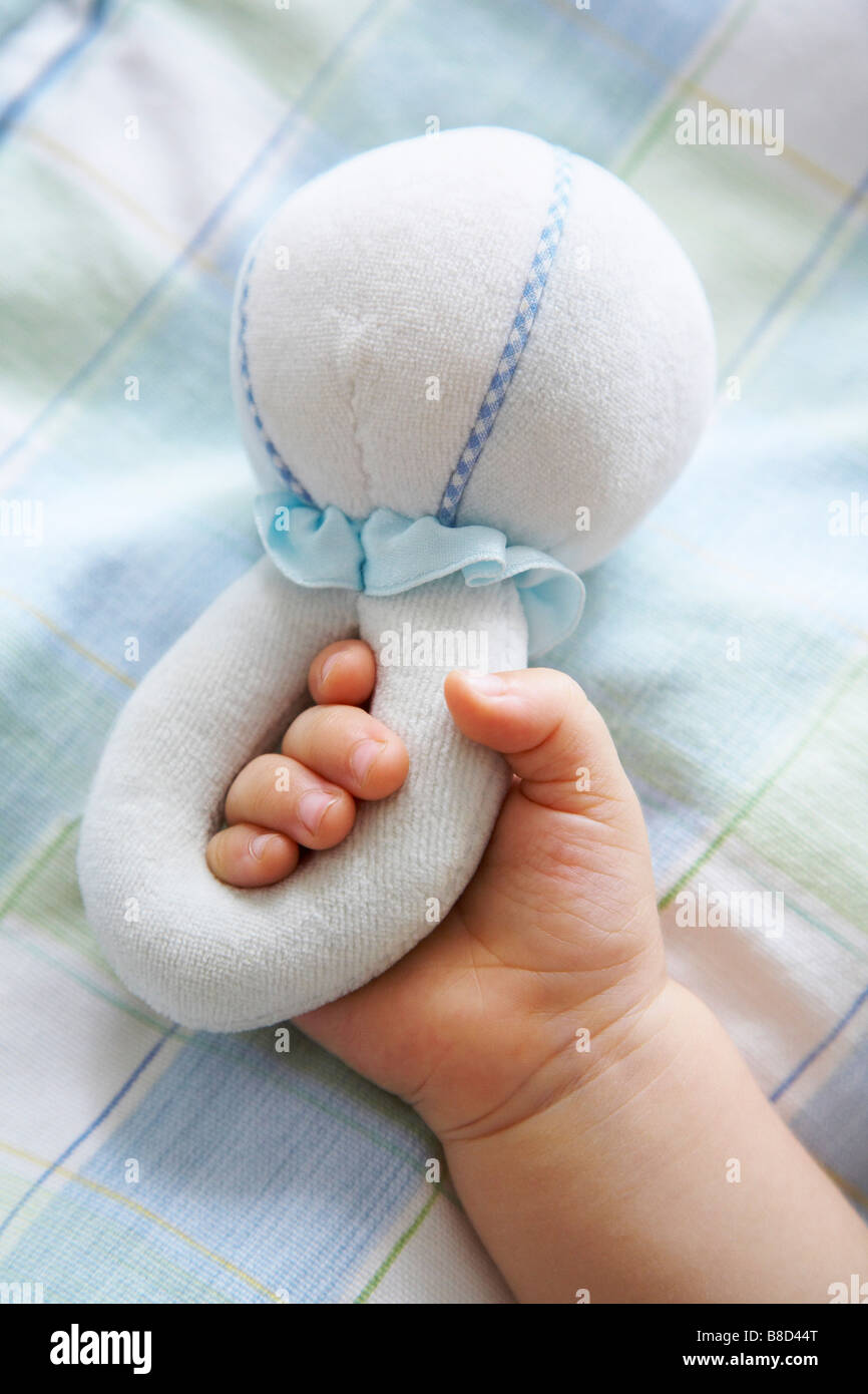 Baby Holding Plush Rattle Stock Photo - Alamy