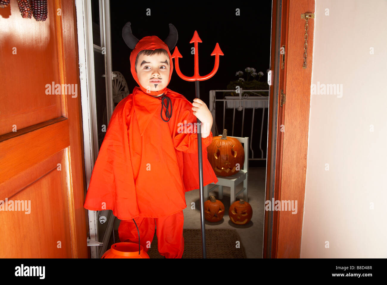 Boy Dressed as Devil Trick or Treating Door Stock Photo - Alamy