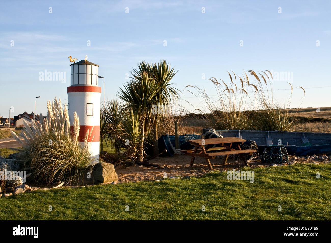 Artificial miniature lighthouse and picnic table by the roadside in ...