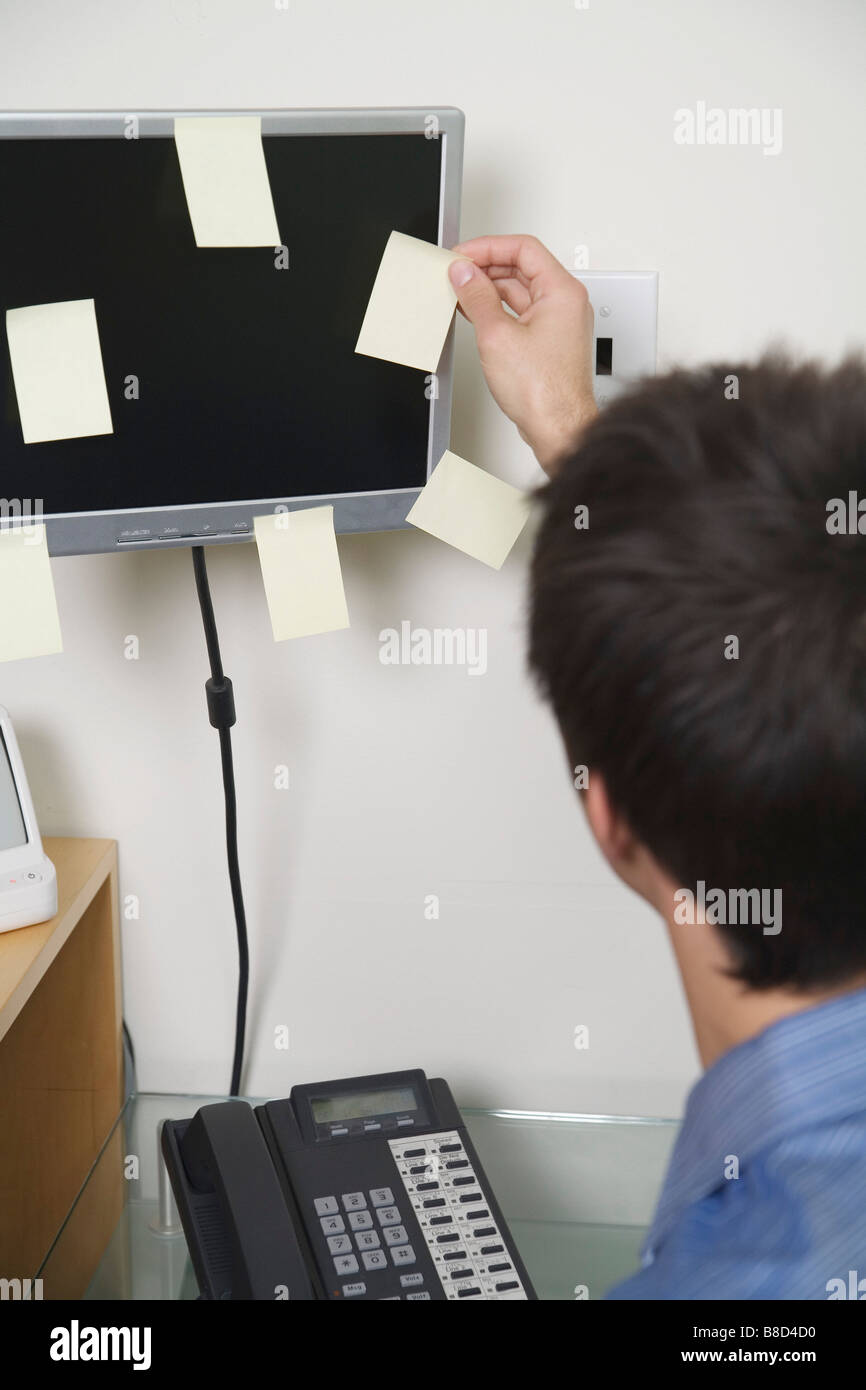 Man Putting Sticky Notes Monitor Stock Photo - Alamy