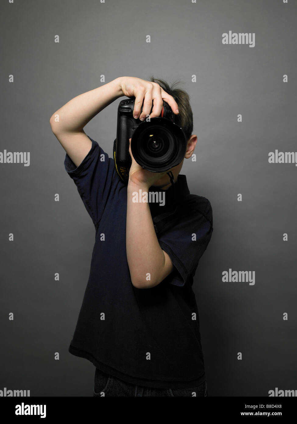 Young boy Using Camera Stock Photo - Alamy