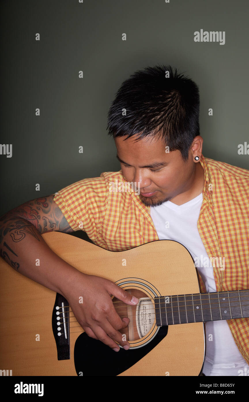 Filipino male playing guitar hi-res stock photography and images - Alamy