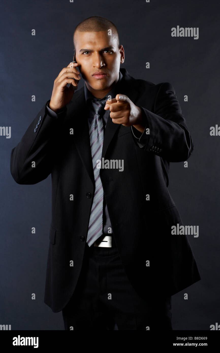 Man Pointing Cell Phone Studio Stock Photo - Alamy