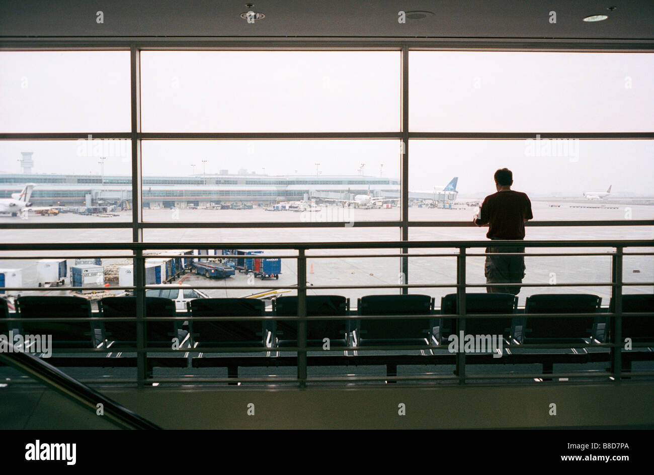 Man Looking out Airport Window Stock Photo - Alamy