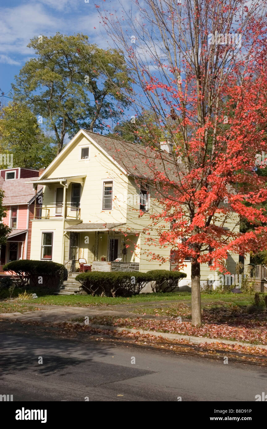 White residential house with autumn foliages trees in Ithaca, NY, USA ...