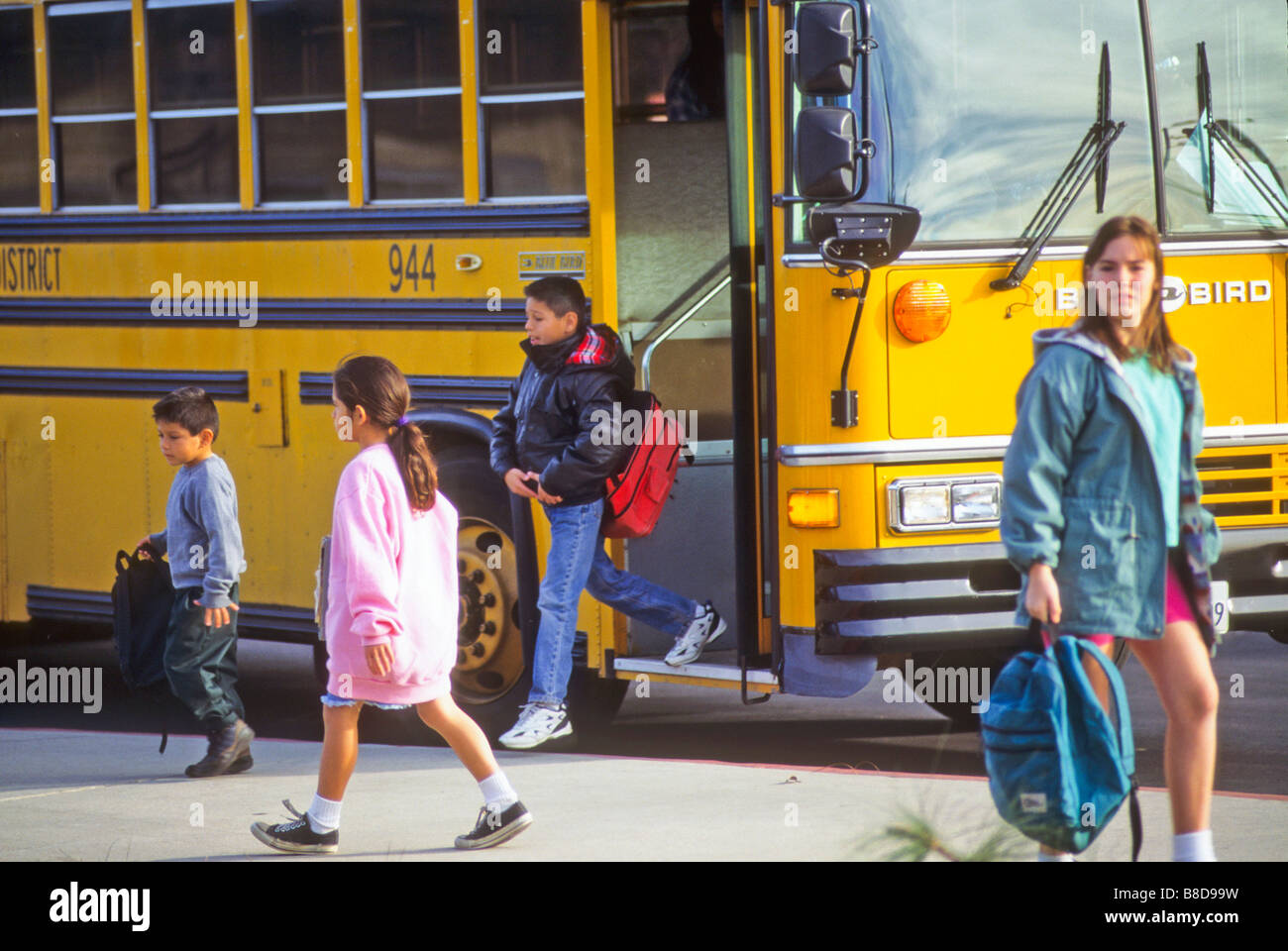 Children come off of school bus onto sidewalk in front of school safe ...