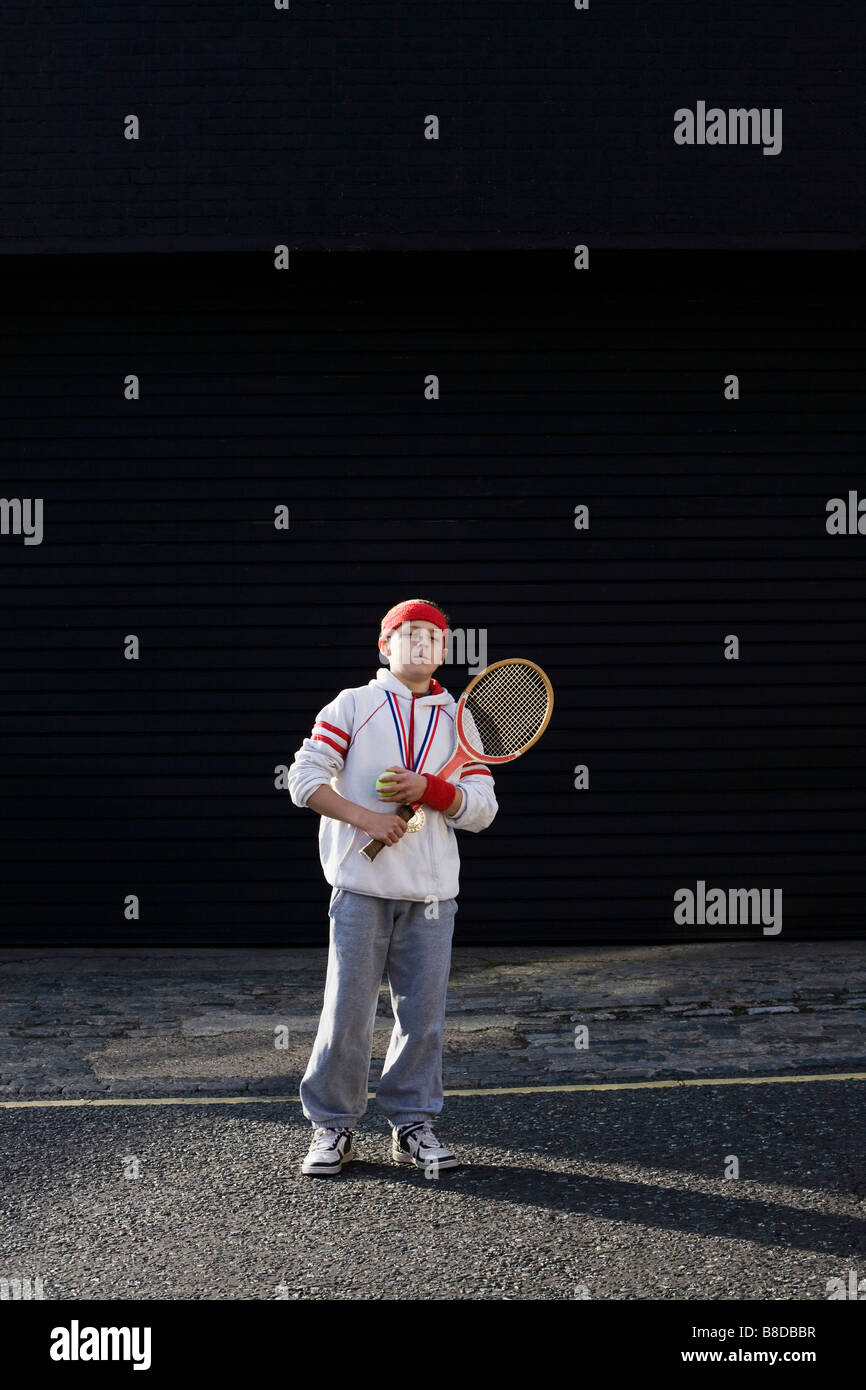 Boy holding tennis racket Stock Photo - Alamy