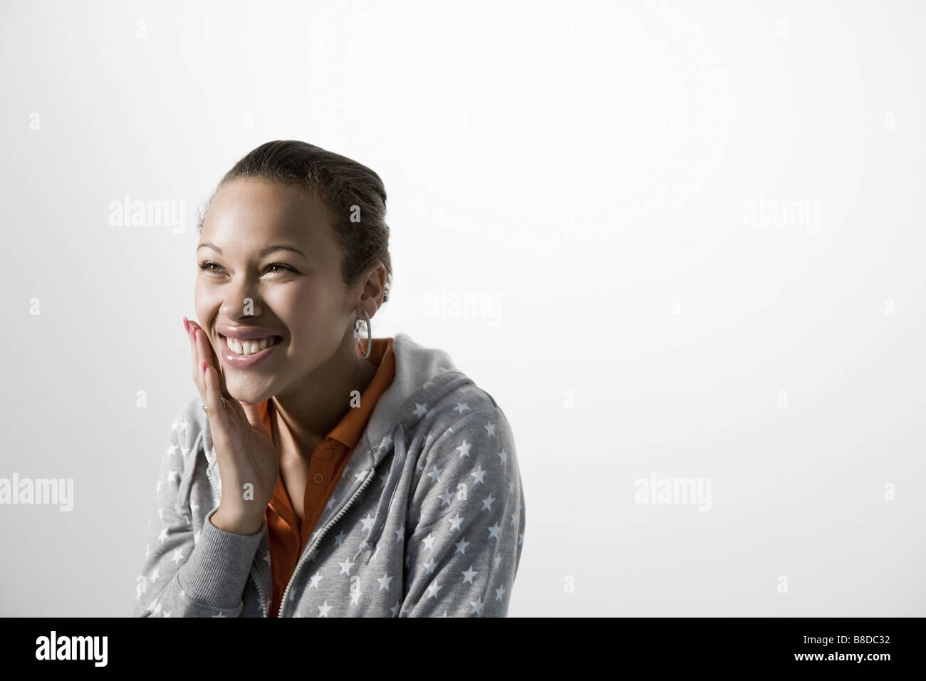 Young woman touching her cheek, smiling, close-up view Stock Photo - Alamy