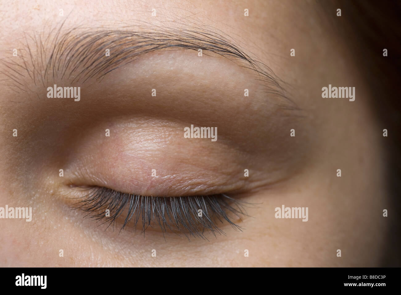 Close-up of young woman's closed eye Stock Photo - Alamy