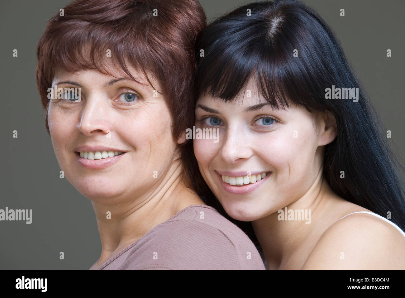 Studio portrait of young woman embracing mother Stock Photo - Alamy
