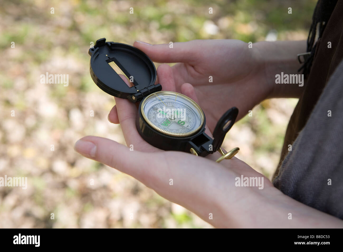 Close-up of womans hands with compass Stock Photo - Alamy