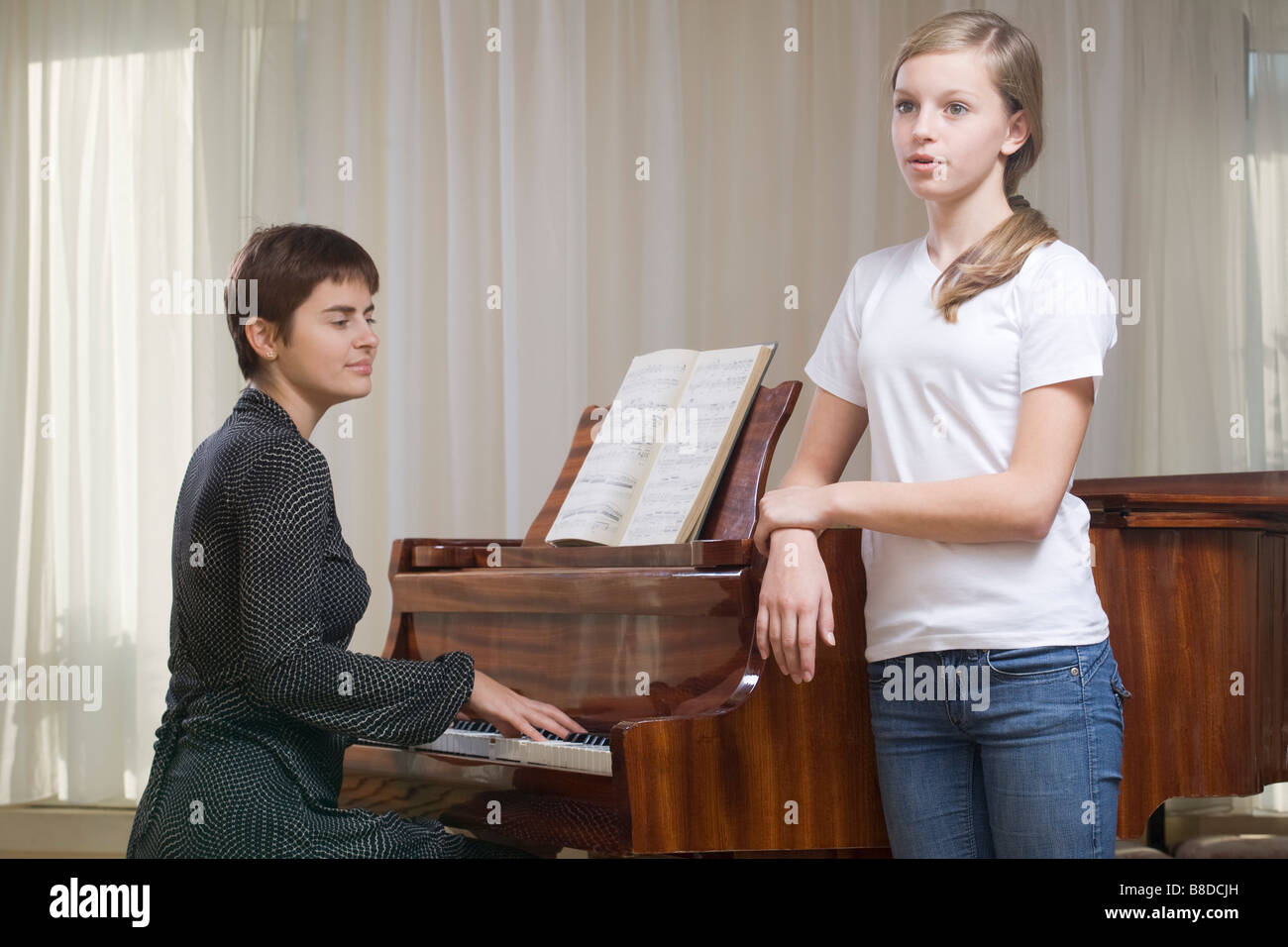 Woman Singing Playing Piano Stock Photos & Woman Singing Playing Piano ...