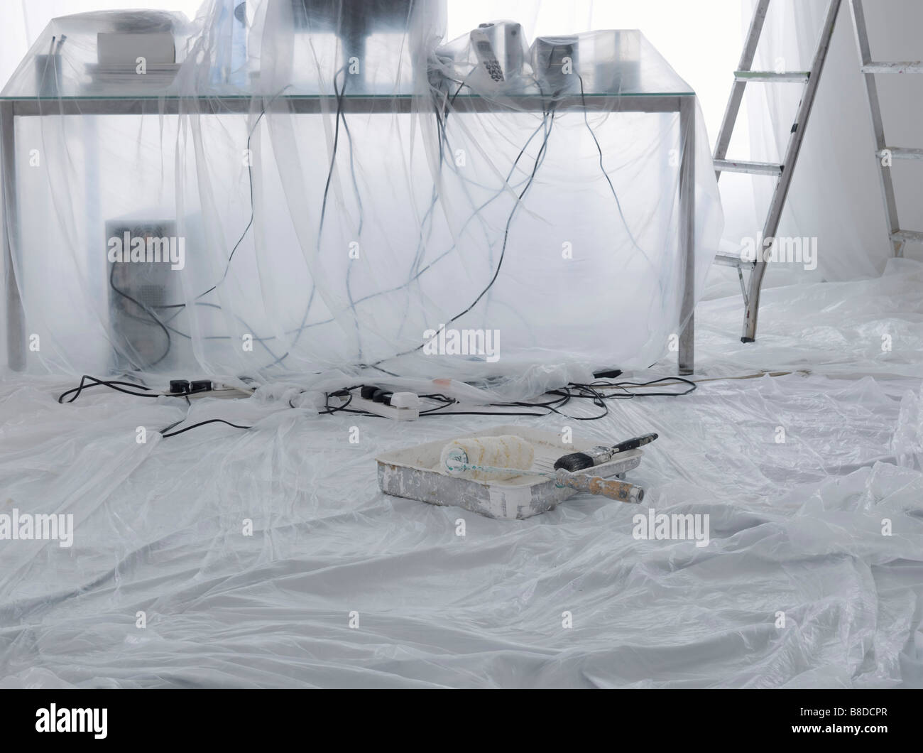 Messy desk with computer and cables covered in dust sheets Stock Photo ...