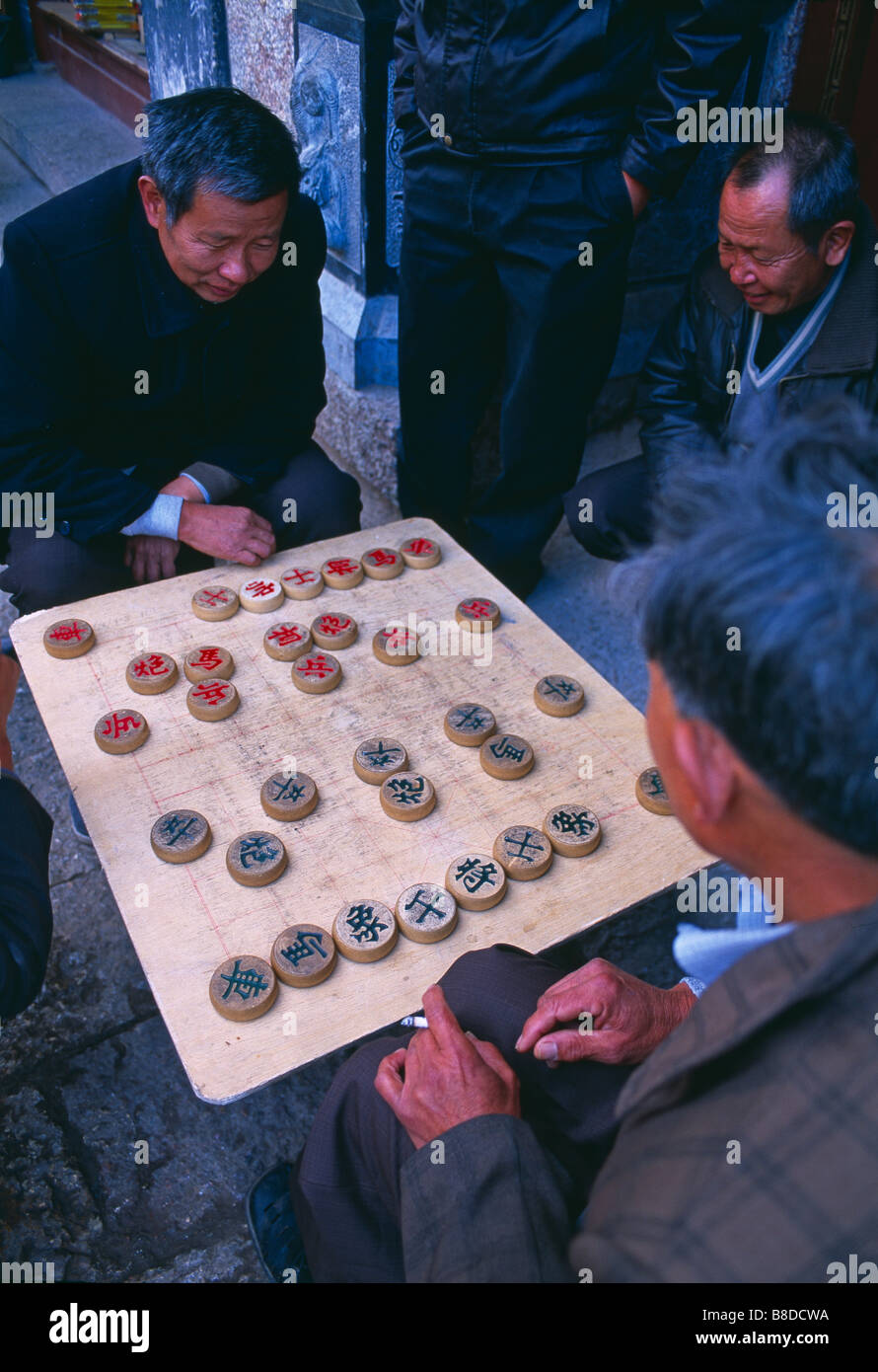 Chinese men playing boardgame, Lijiang, Yunnan Province, China Stock ...