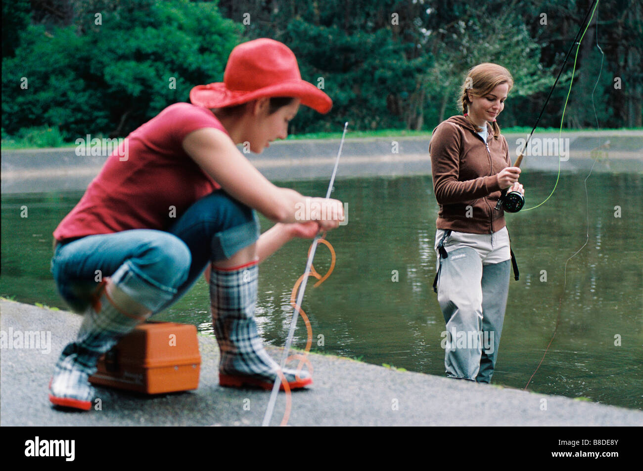 Two Young Women Preparing to Fish Stock Photo - Alamy