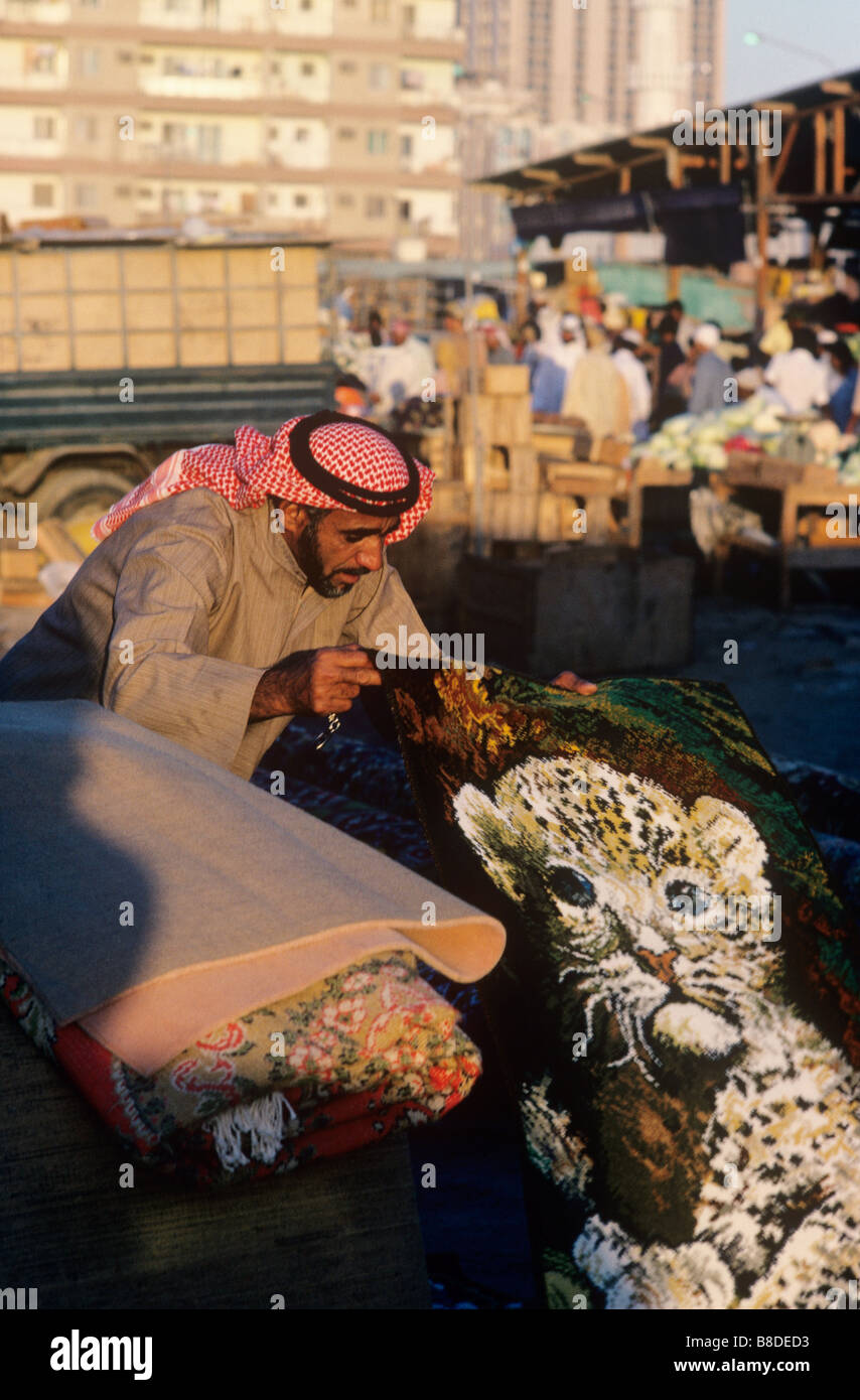United Arab Emirates, A carpet seller proudly displays his wares for ...