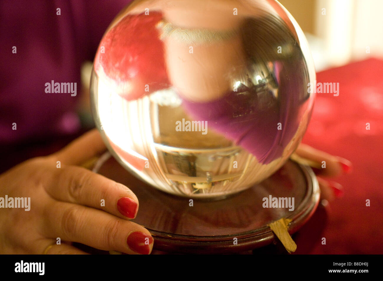 Clairvoyant with hands round a crystal ball Stock Photo - Alamy