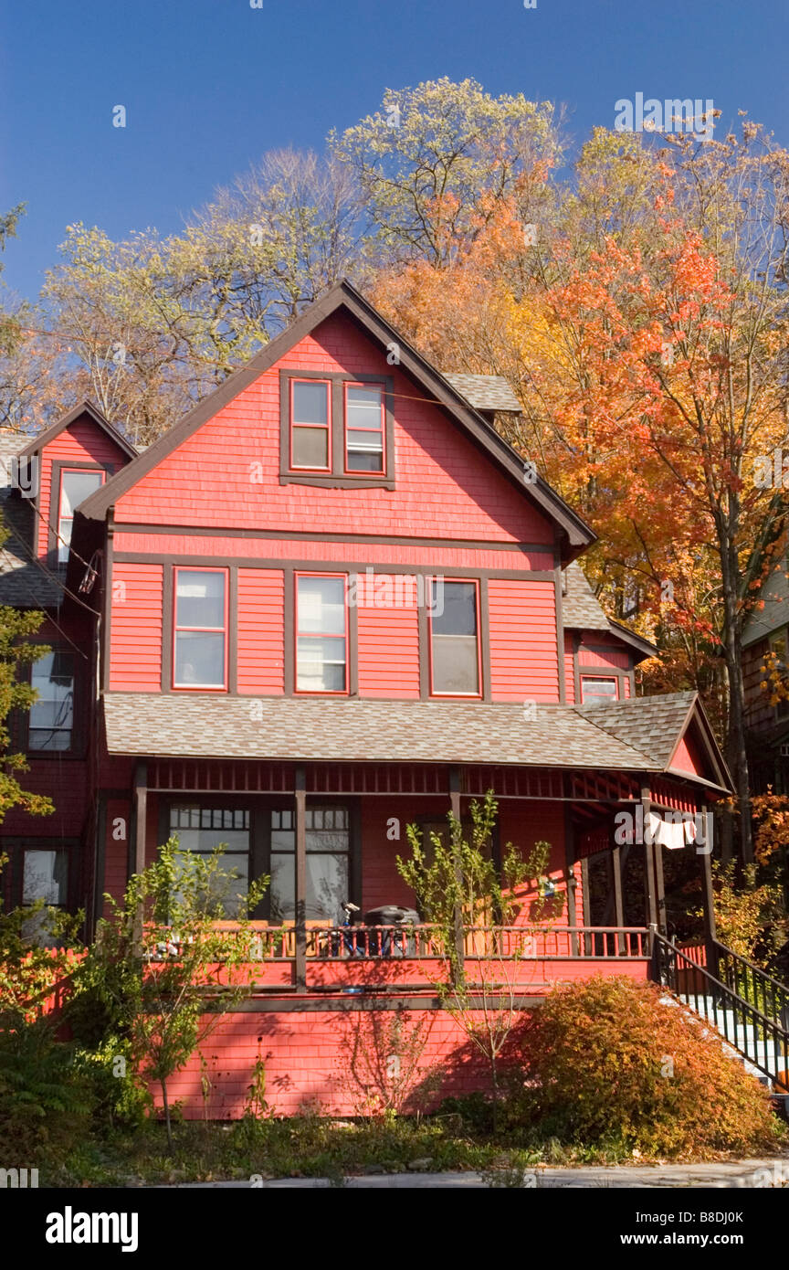 Red residential house with autumn foliages trees in Ithaca, NY, USA ...