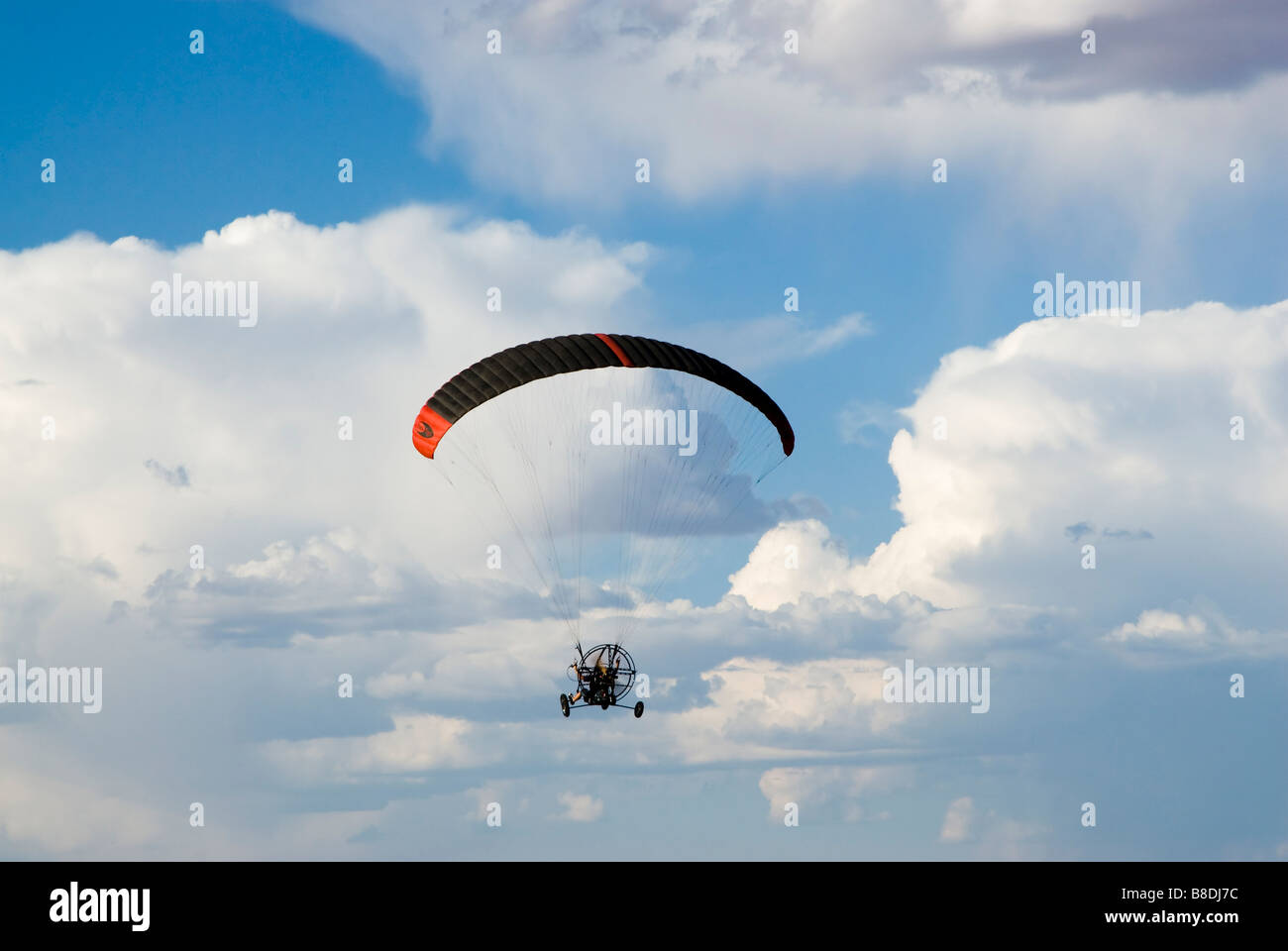 paraglider pilot in flight against dramatic clouds Stock Photo - Alamy