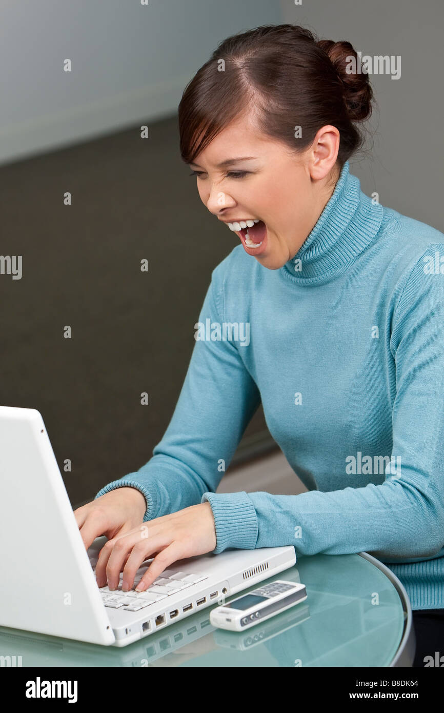 A beautiful young oriental woman getting angry with her laptop Stock ...
