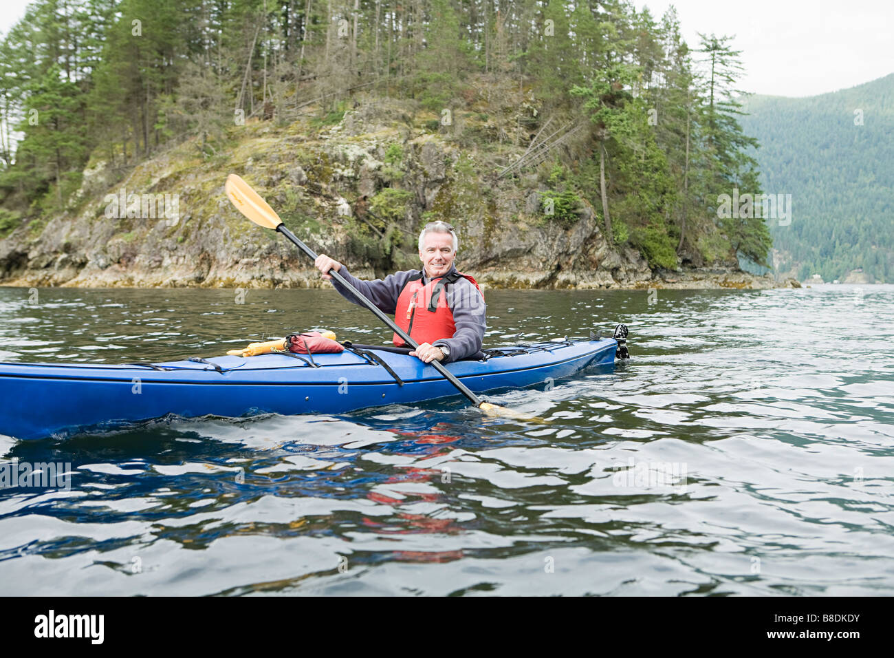 Man kayaking in fjord Stock Photo - Alamy