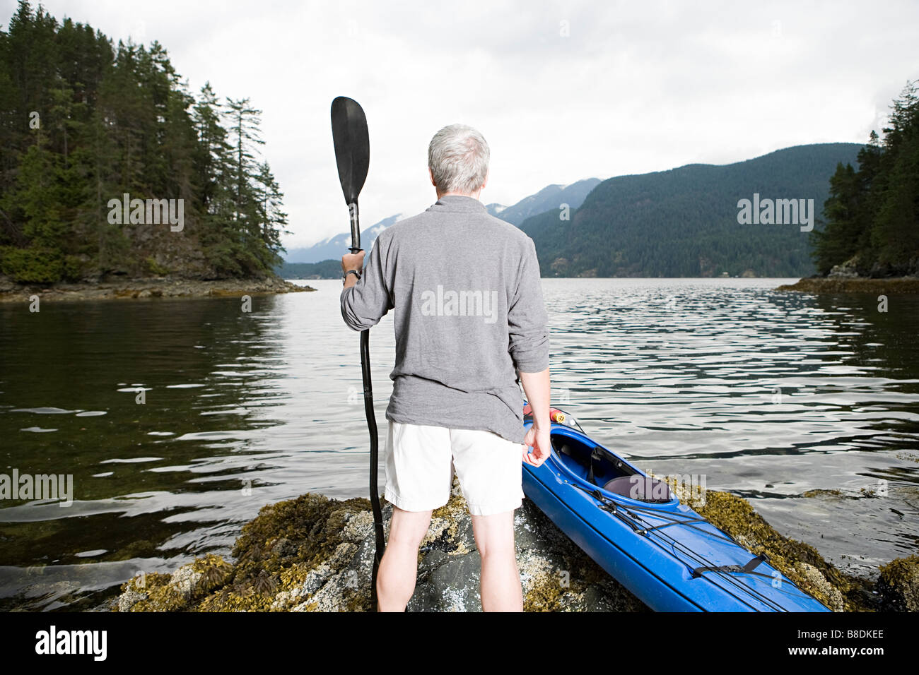 Man with kayak Stock Photo - Alamy