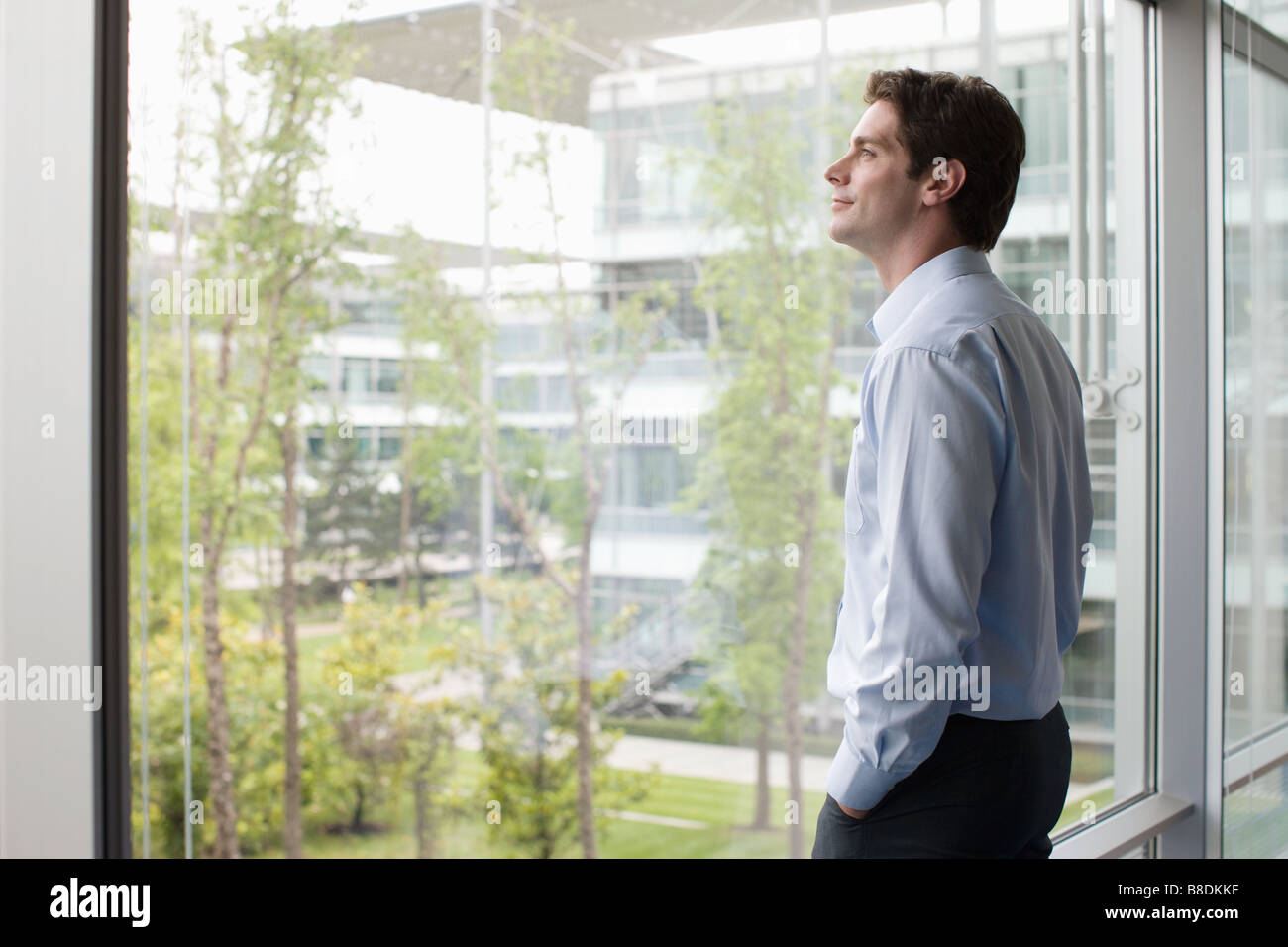 Man looking through window Stock Photo - Alamy