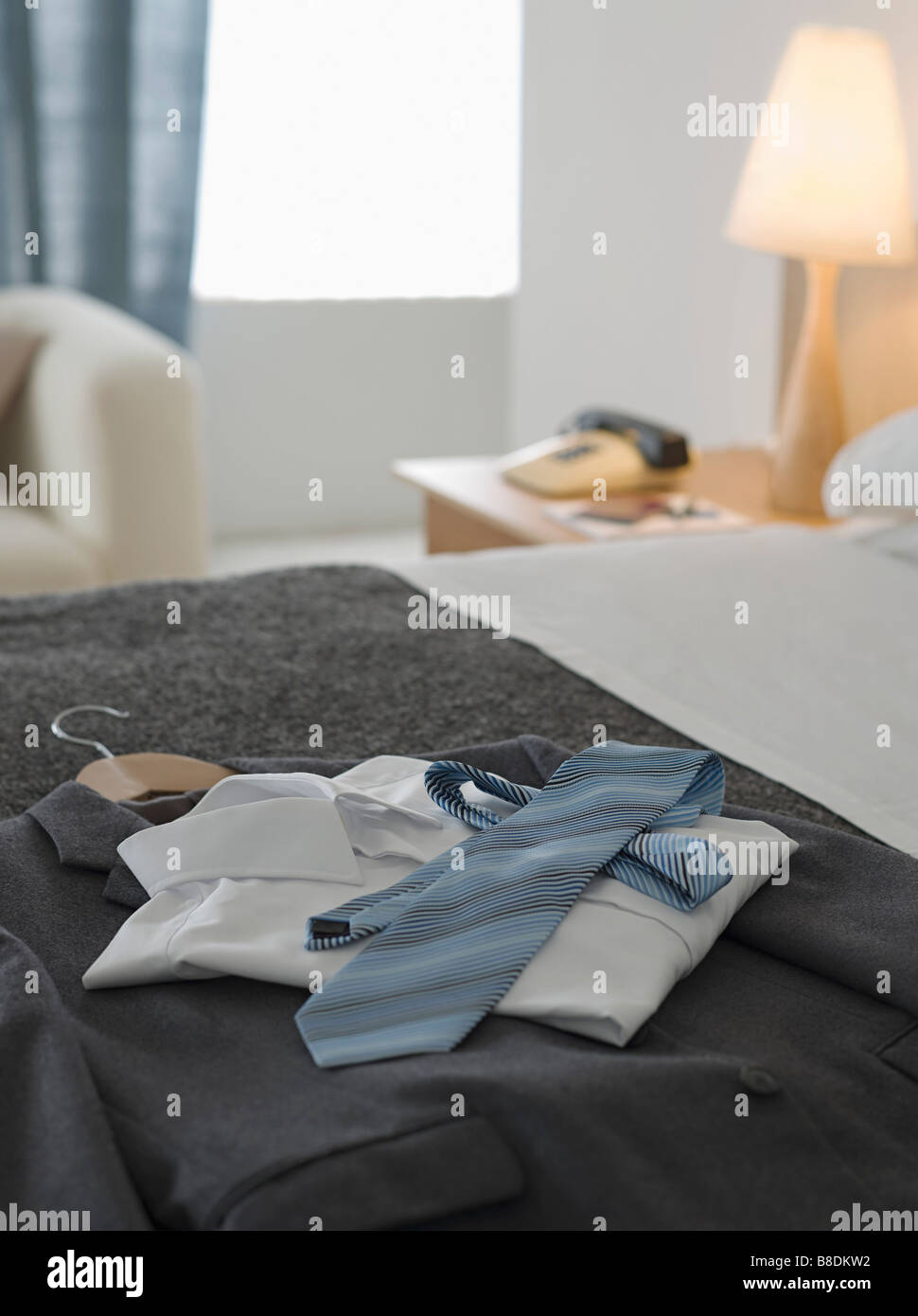 Suit and tie on a hotel bed Stock Photo - Alamy